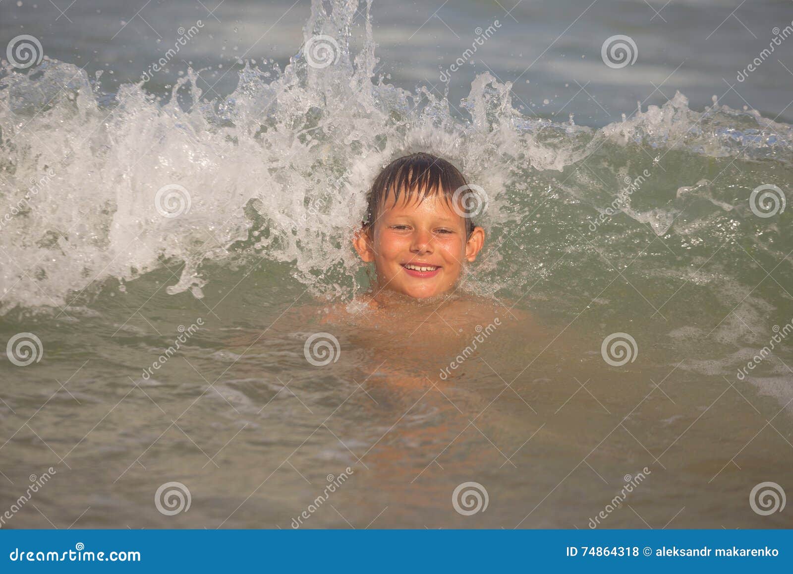 Boy Frolics in the Sea with Splashes and Waves Stock Photo - Image of ...