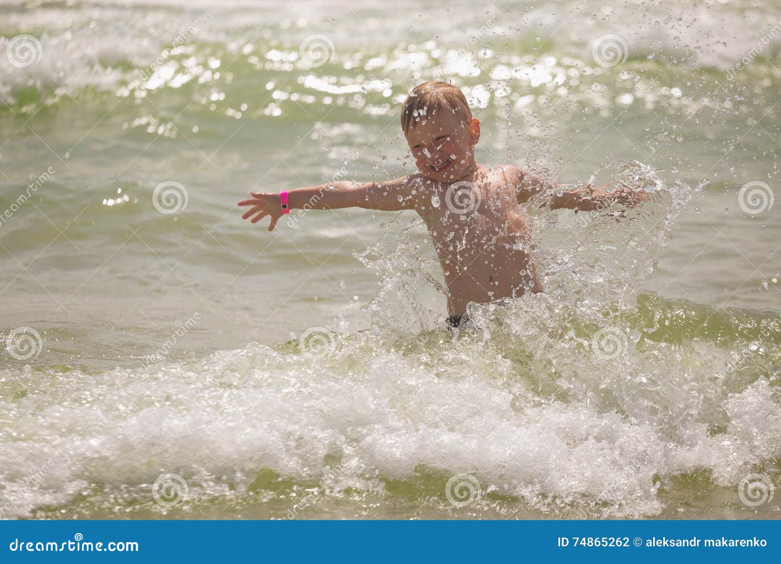 Boy Frolics in the Sea with Splashes and Waves Stock Photo - Image of ...