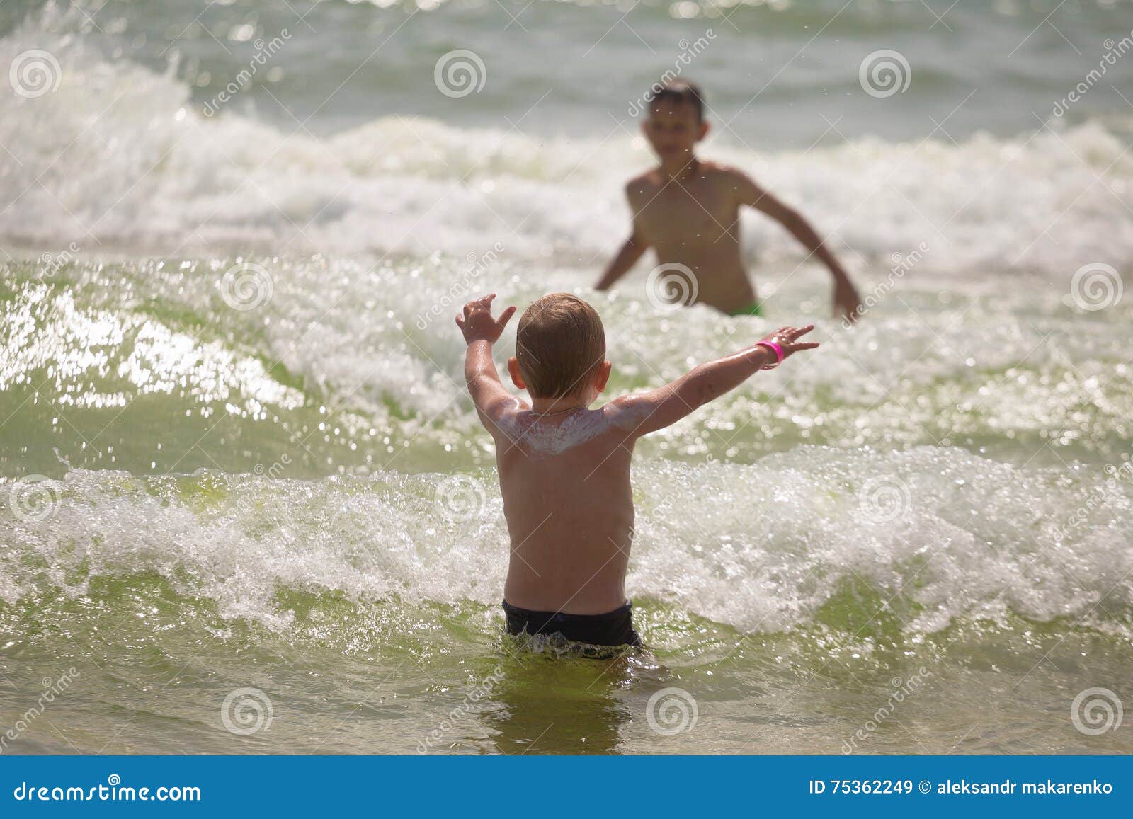 Boy Frolics in the Sea with Splashes and Waves Stock Image - Image of ...