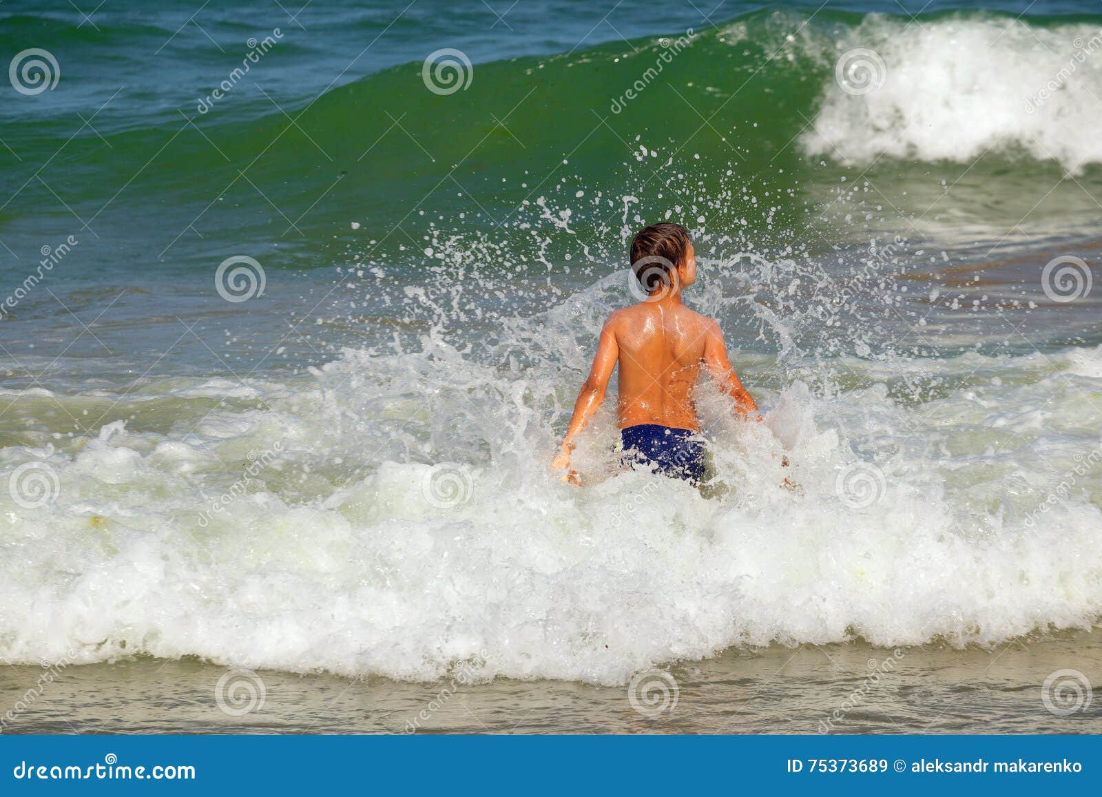 Boy Frolics in the Sea with Splashes and Waves Stock Image - Image of ...