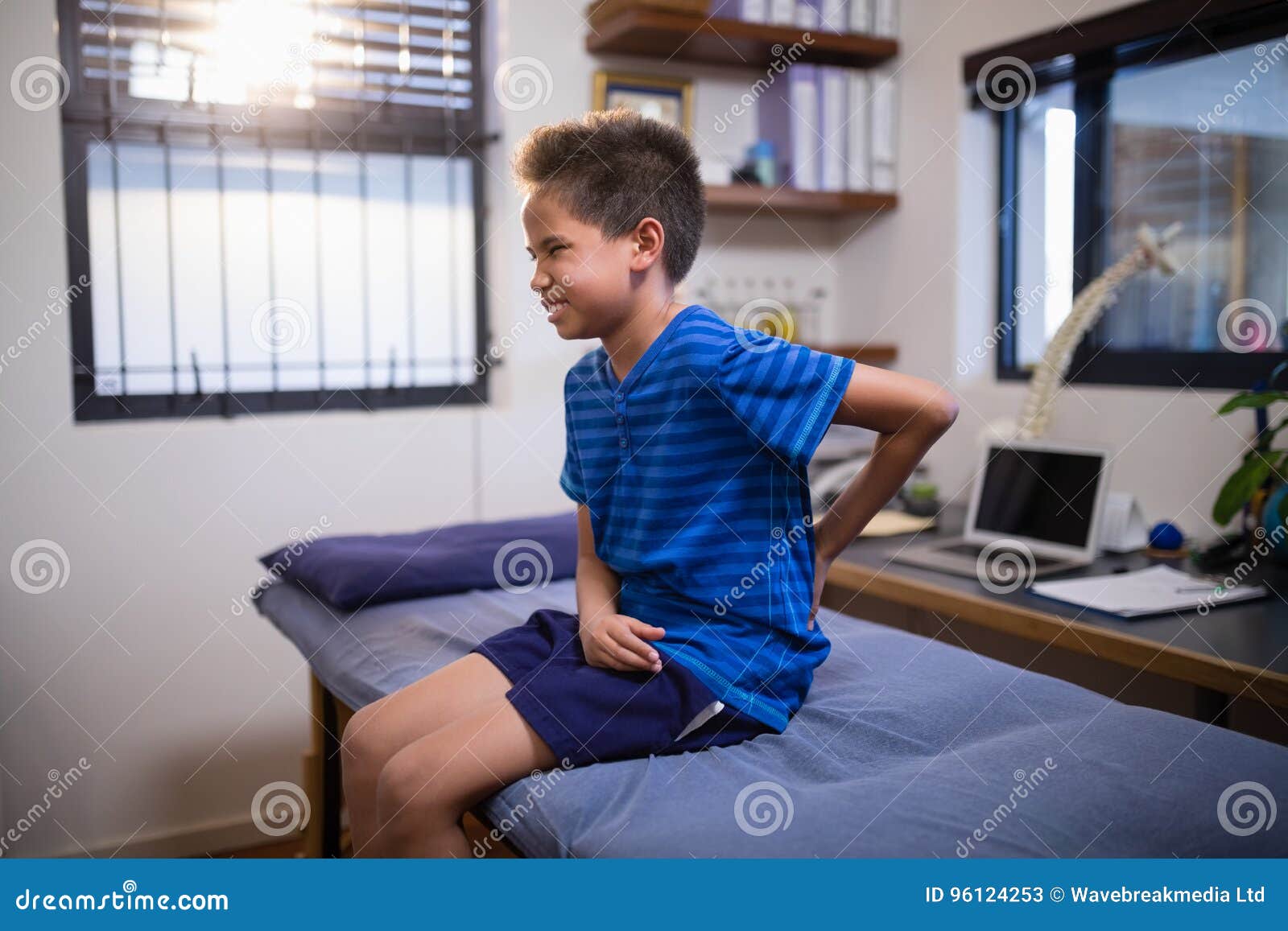 Boy Frowning with Backache while Sitting on Bed Stock Image - Image of ...