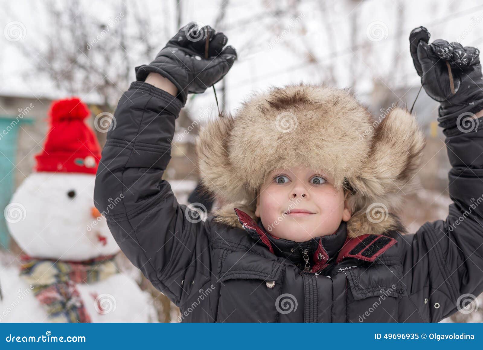 The Boy in a Fur Hat Around Snowman Stock Image - Image of jacket ...
