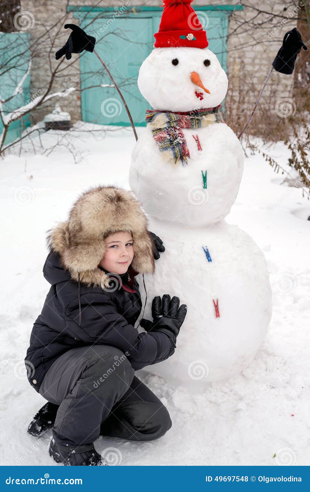 The Boy in a Fur Hat Around Snowman Stock Photo - Image of head ...