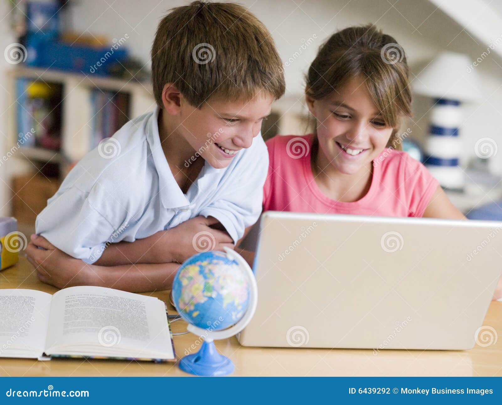 Boy and Girl Doing Their Homework on a Laptop Stock Photo - Image of ...