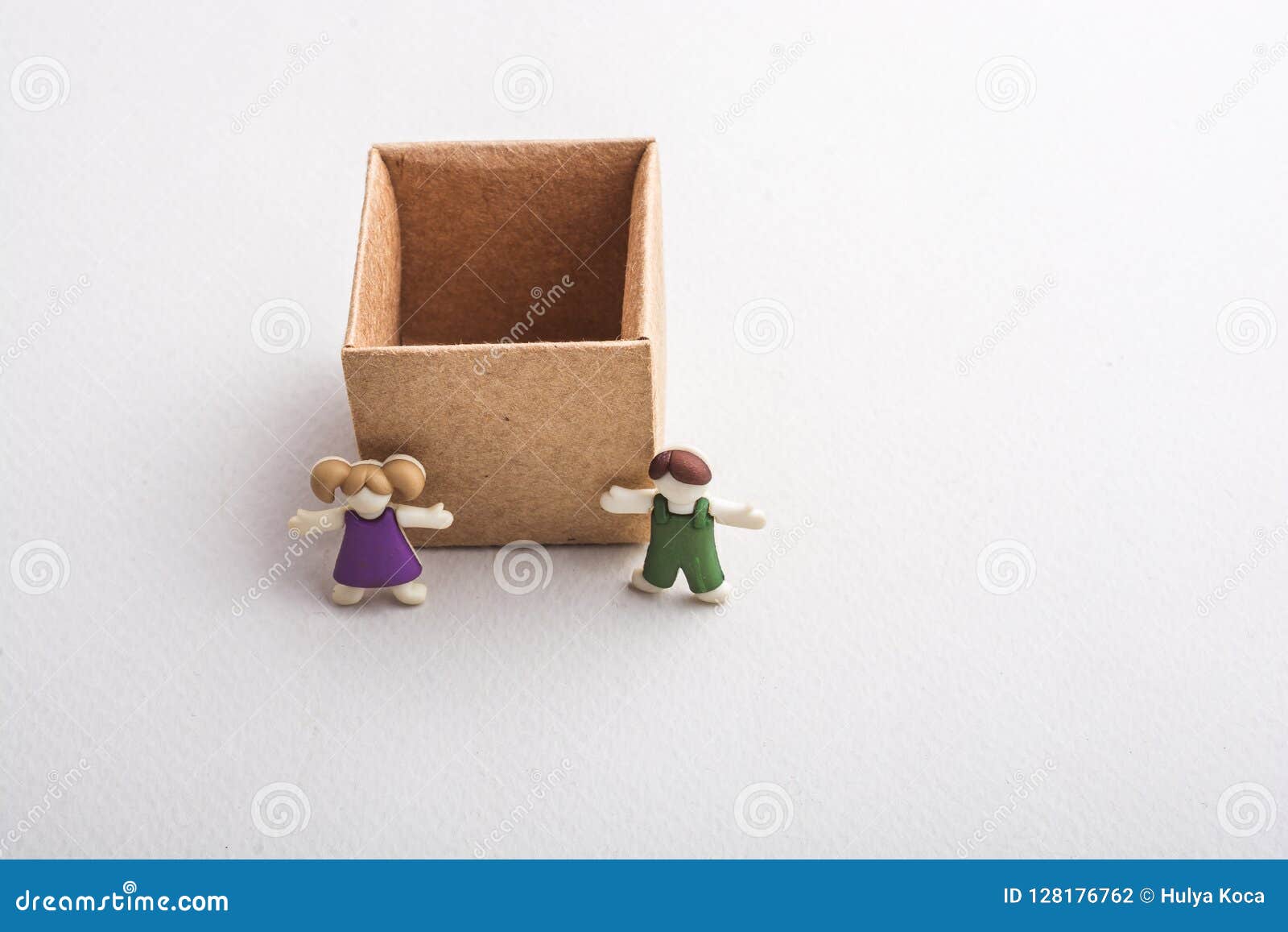 Boy and Girl Figurine beside an Empty Box Stock Photo - Image of kids ...