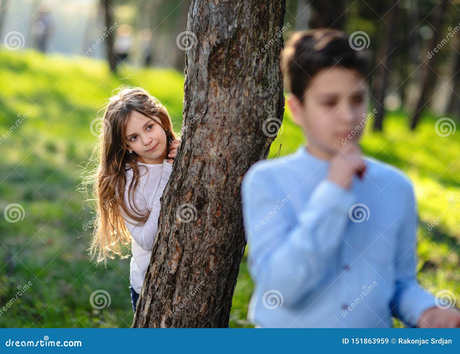 Boy And Girl Playing Hide And Seek In The Park Girl Watching On Boyfriend Stock Image Image 2475