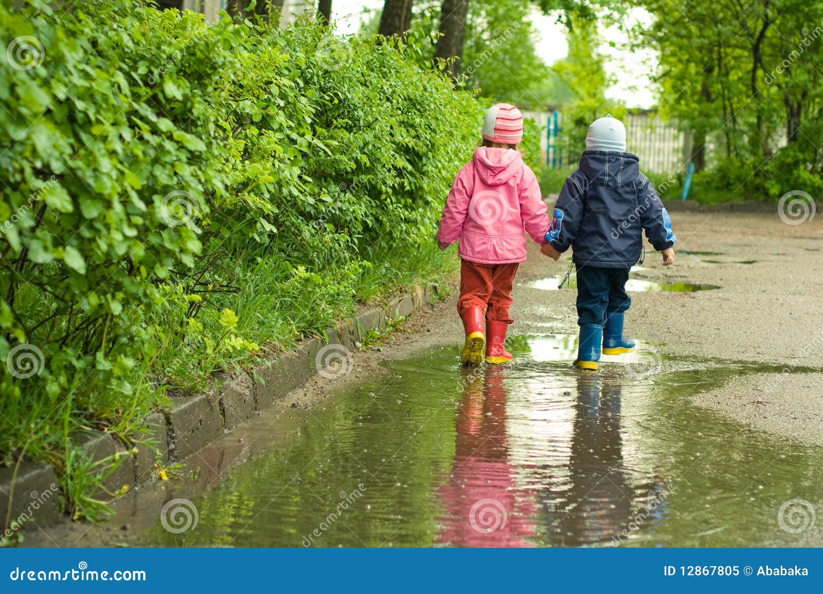 Boy and girl in the puddle stock image. Image of silhouette - 12867805