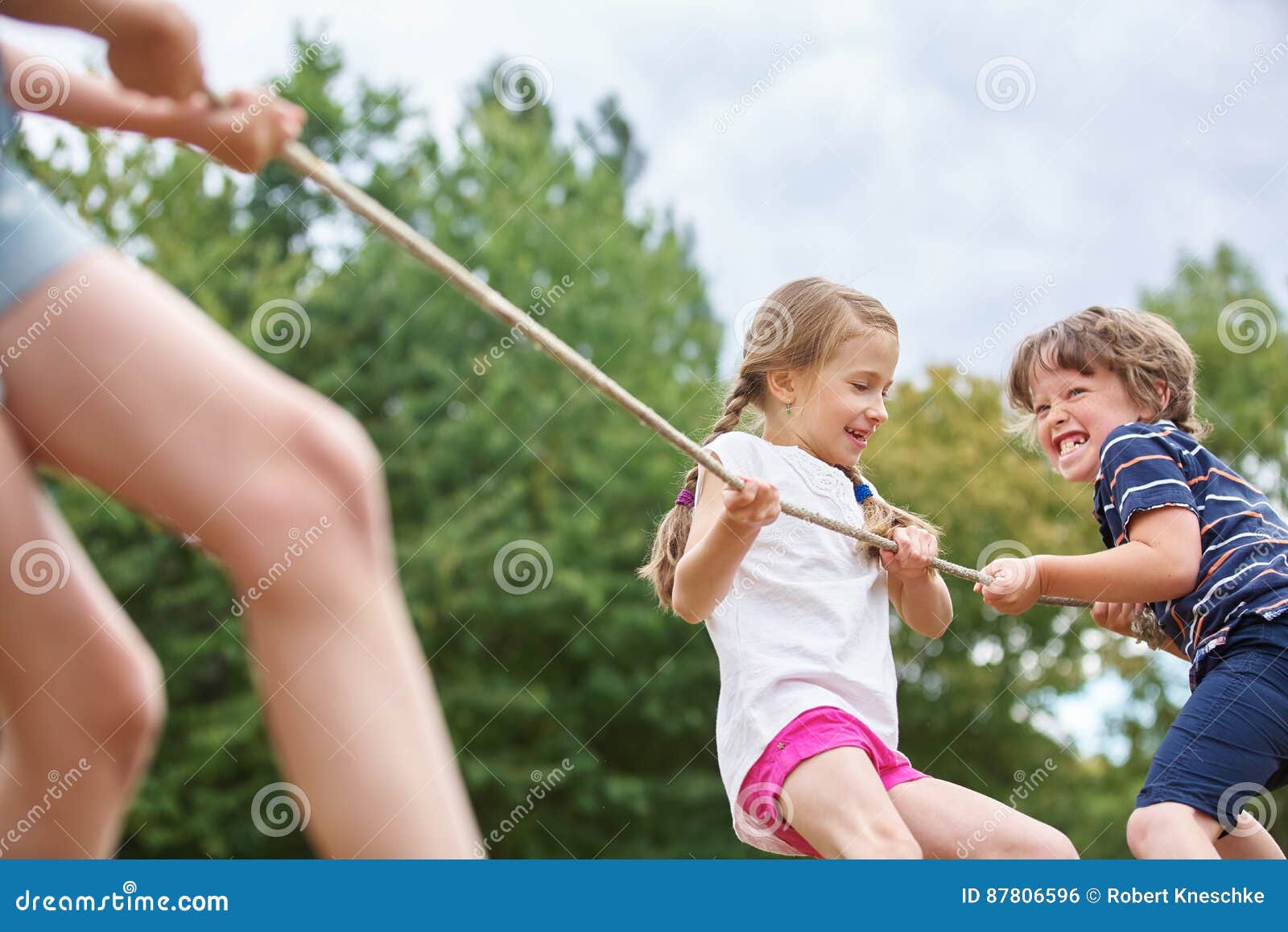 Boy and Girl Pulling a Rope Stock Photo - Image of fall, nature: 87806596