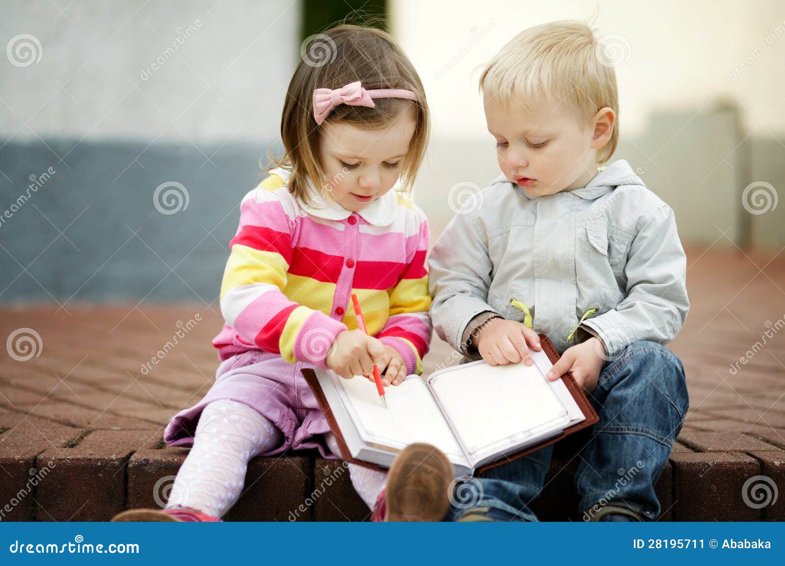 Boy and girl reading book stock image. Image of cheerful - 28195711