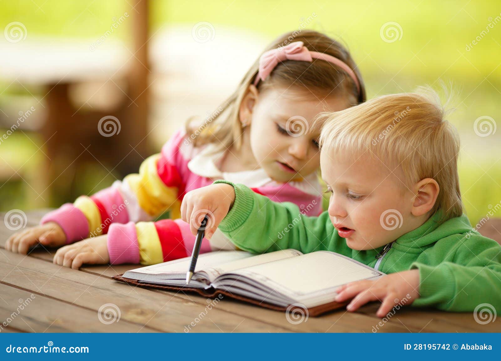 Boy and Girl Reading a Book Stock Photo - Image of book, outdoors: 28195742