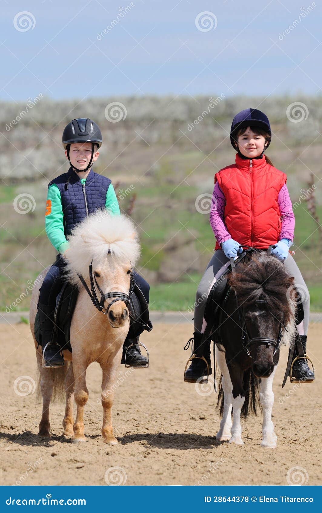 Boy and girl riding ponies stock photo. Image of child - 28644378