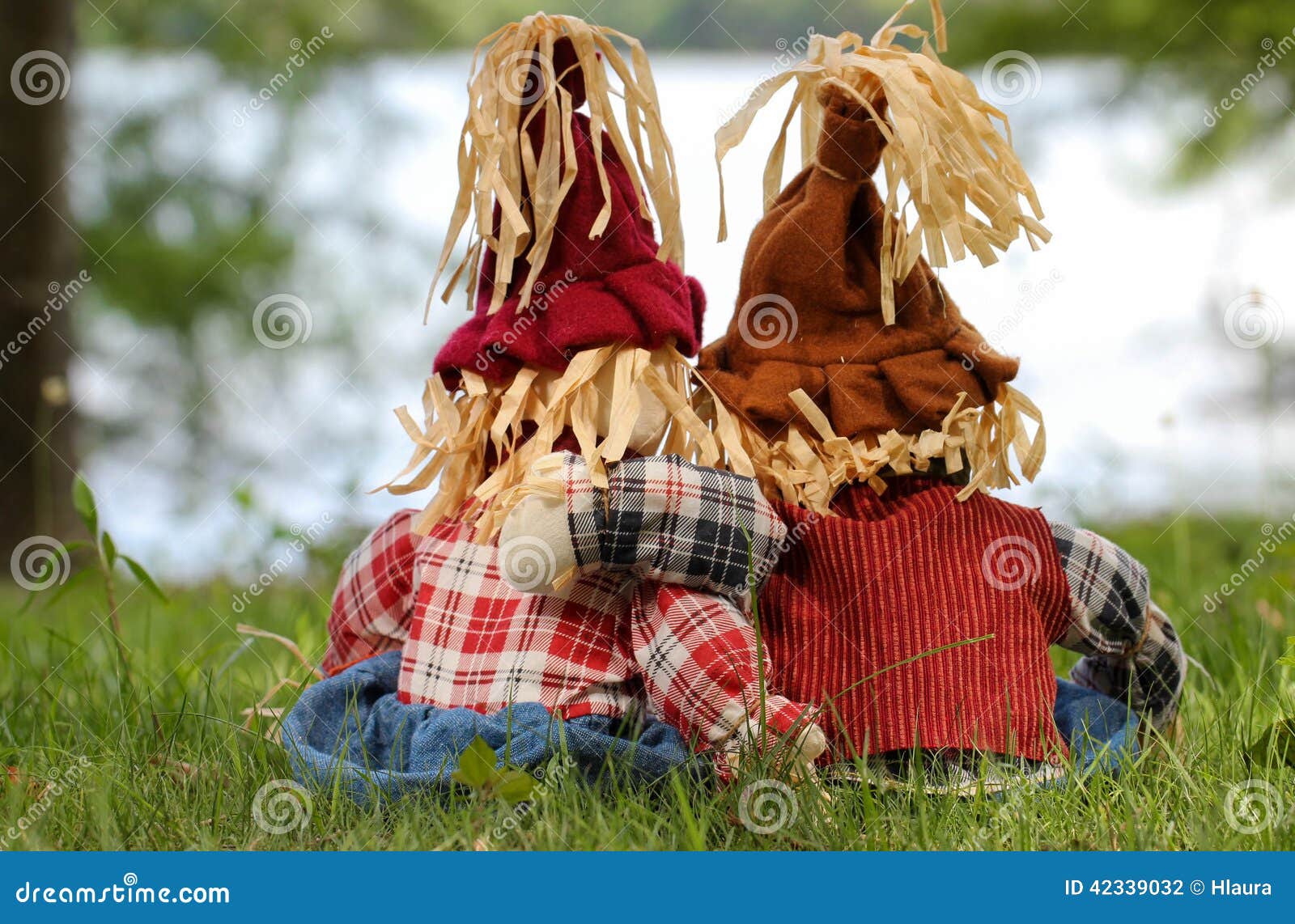 Boy And Girl Scarecrows Back View Sitting By Lake Stock Photography ...