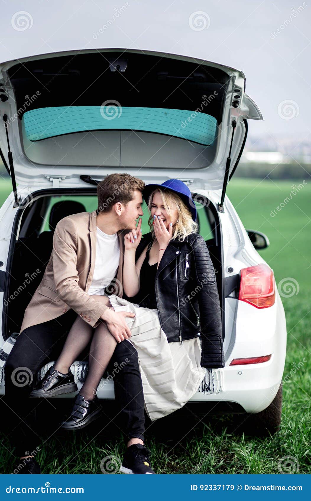 The Boy and the Girl Sit on a Car Trunk and Laughing Stock Image ...