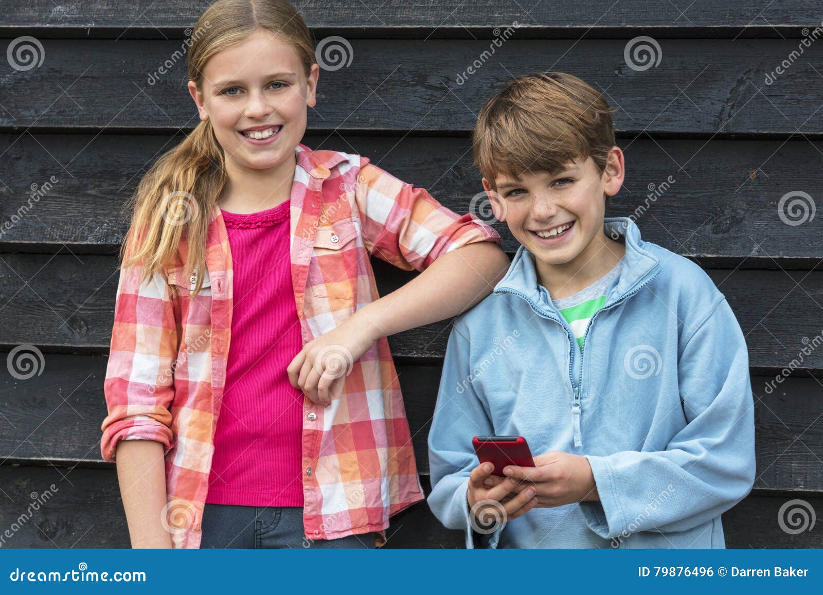 Boy and Girl Smiling Children Using Cell Phone Stock Photo - Image of ...
