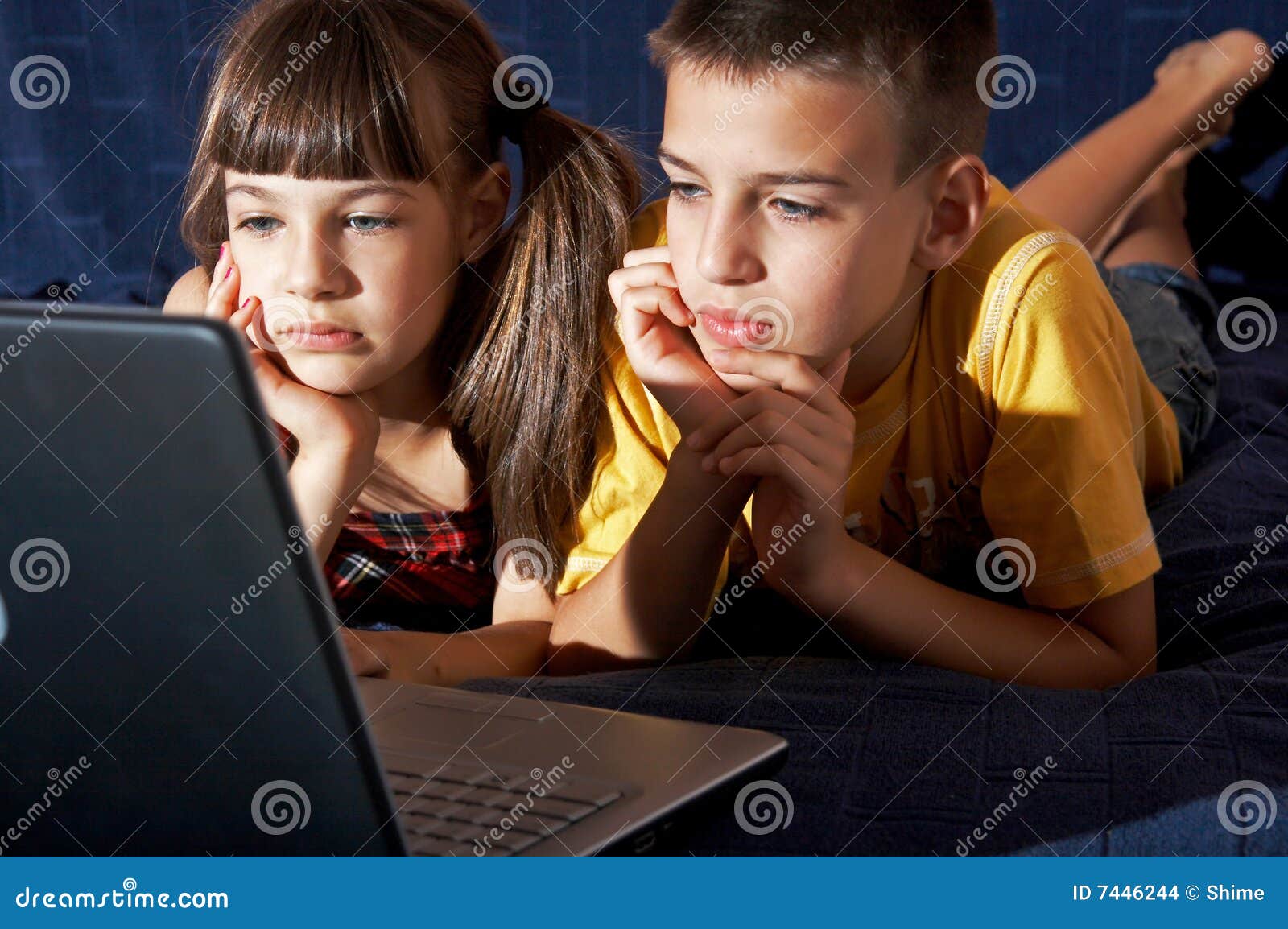 Boy and girl using laptop stock photo. Image of folder - 7446244