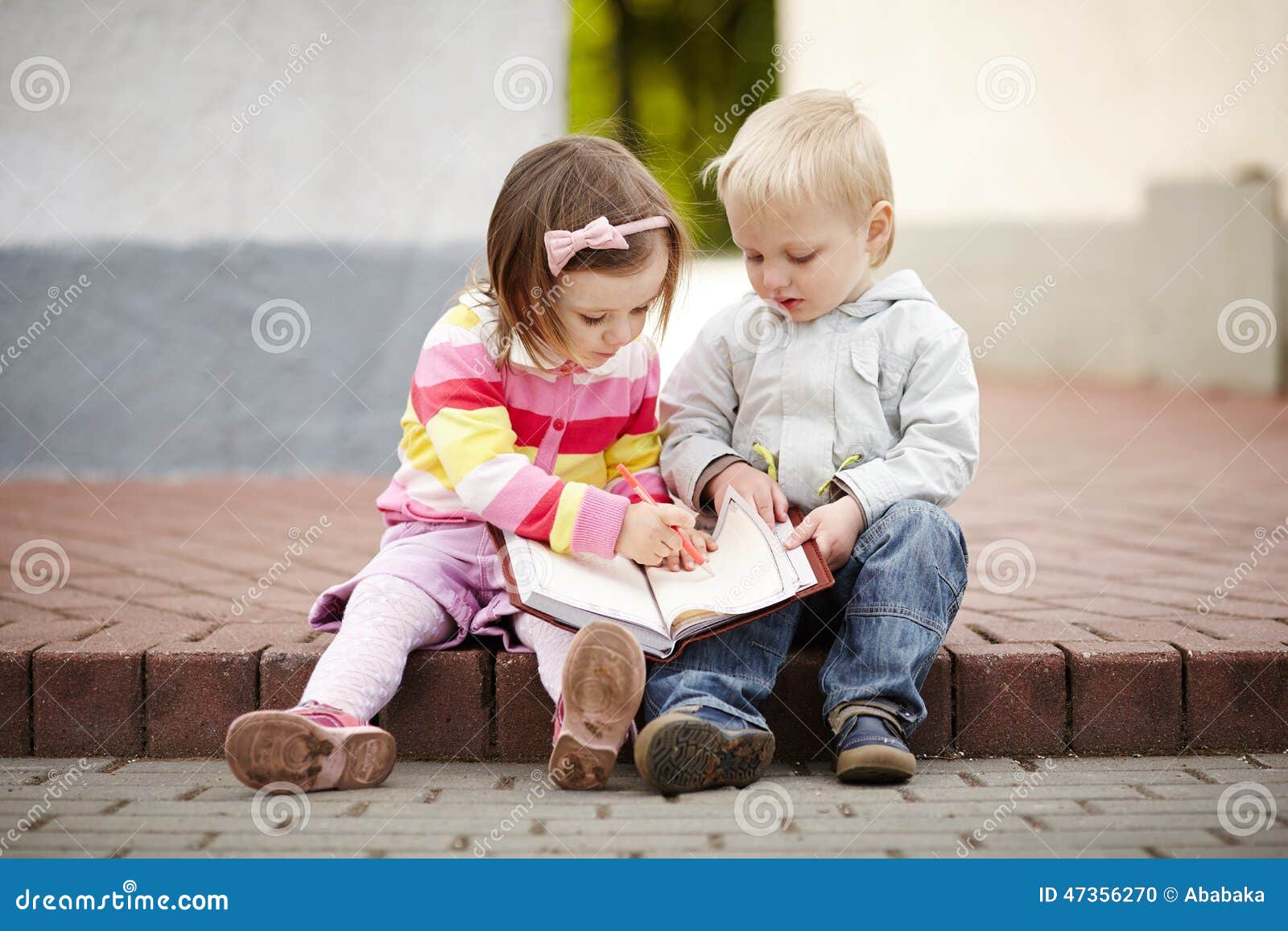 Boy and Girl Writing To Notebook Stock Photo - Image of female, outdoor ...