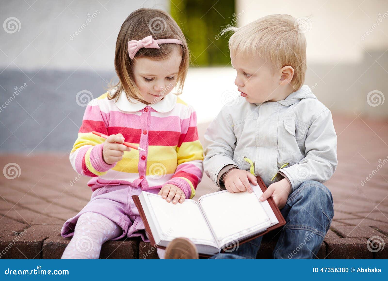 Boy and Girl Writing To Notebook Stock Photo - Image of outdoors ...
