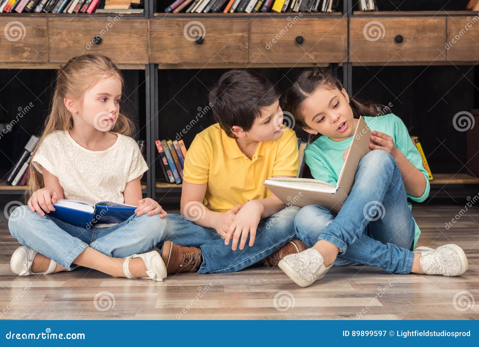 Boy and Girls Reading Books Stock Image - Image of shelves, classmates ...