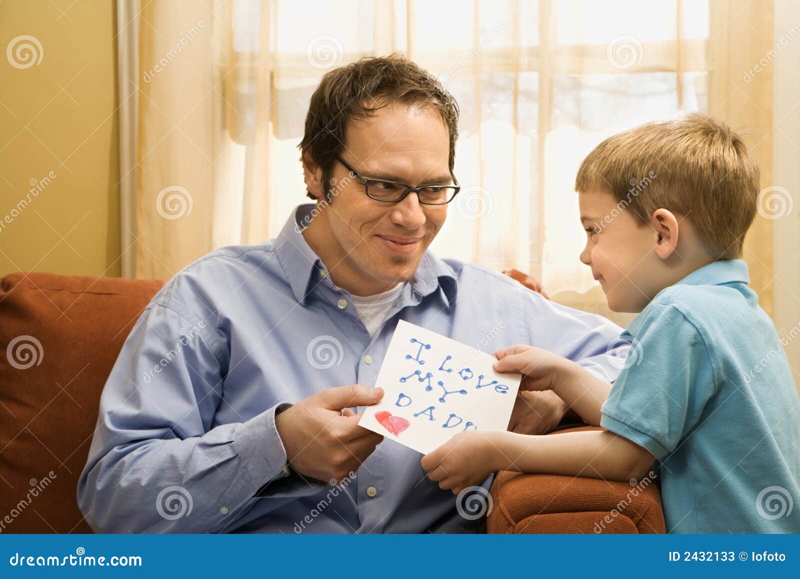 Boy giving dad drawing. stock image. Image of portrait - 2432133