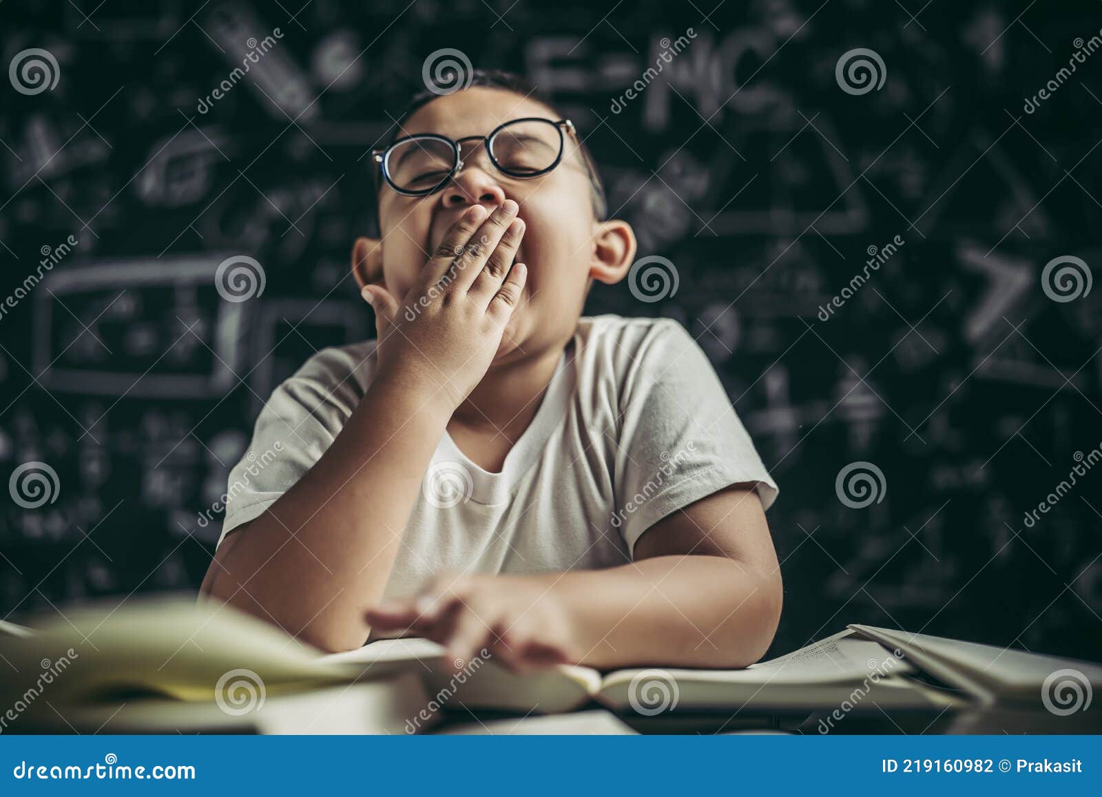 A Boy with Glasses Studying and Drowsy Stock Photo - Image of drowsy ...
