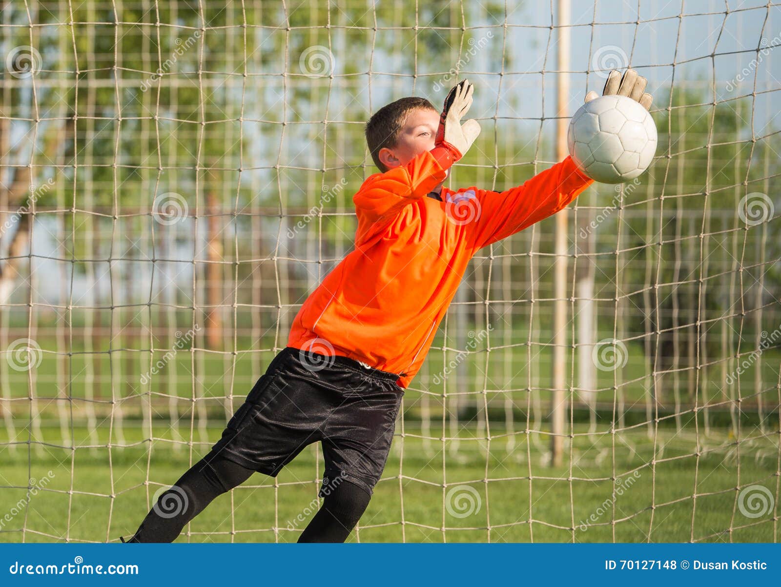 Boy goalkeeper defends stock photo. Image of football - 70127148