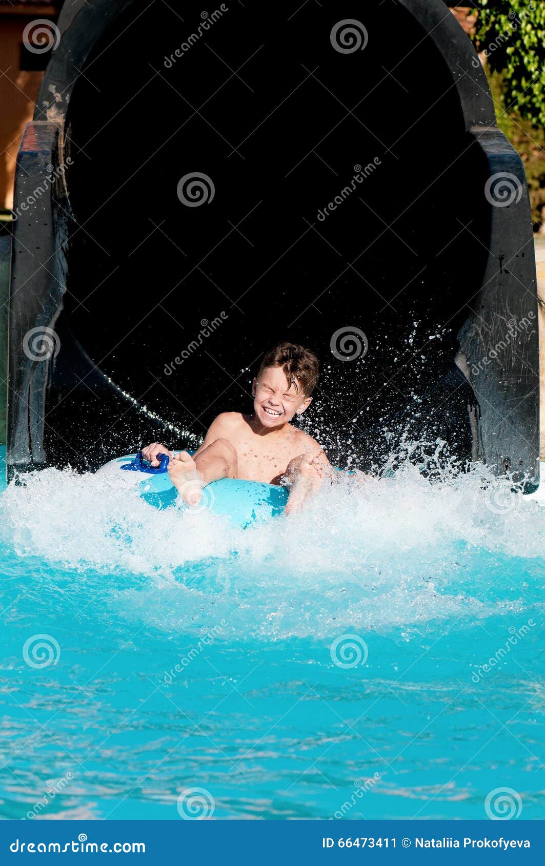 Boy going down water slide stock image. Image of excited - 66473411