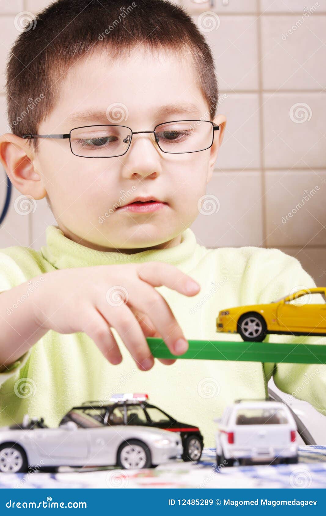 Boy in Green Playing with Cars Stock Image - Image of caucasian, person ...