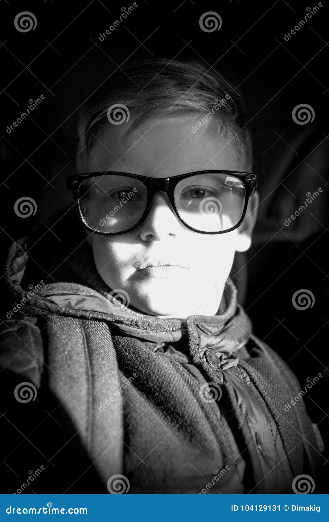 A Boy with Half-lighted Face Looking To the Camera. Boy`s Face in the ...