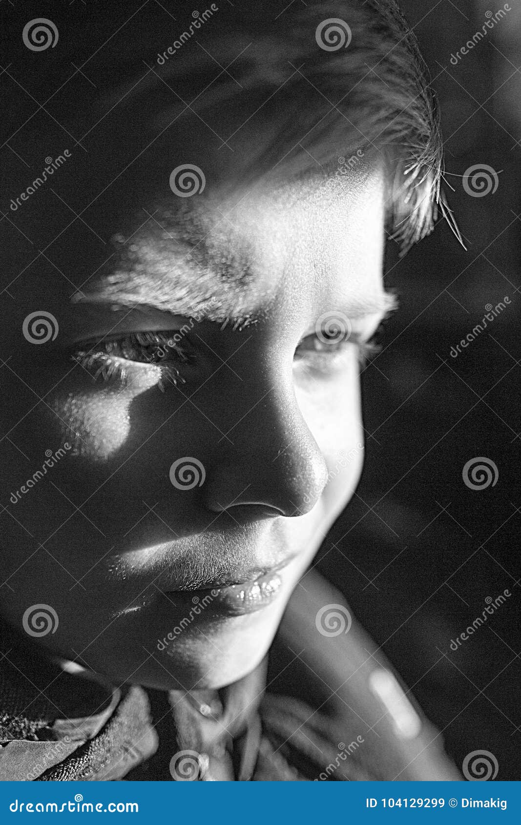 A Boy with Half-lighted Face Looking To the Camera. Boy`s Face in the ...