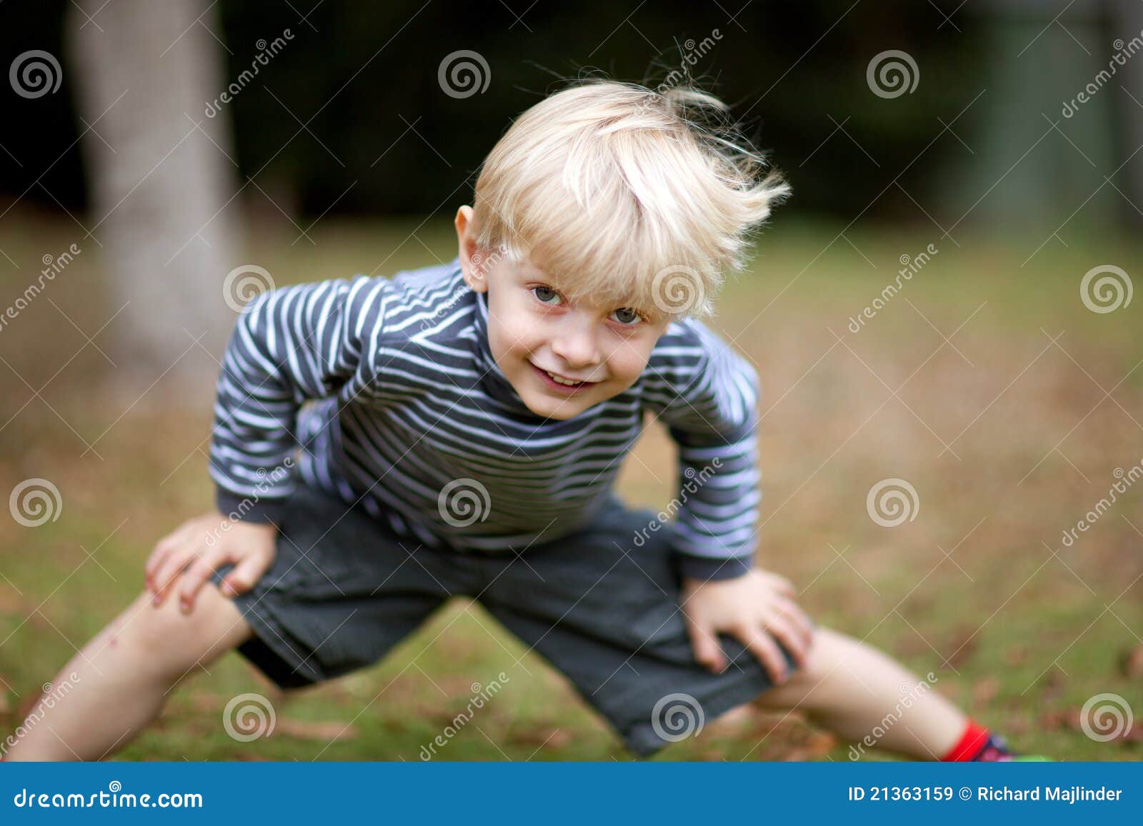 Boy with hands on knee stock image. Image of smiling - 21363159