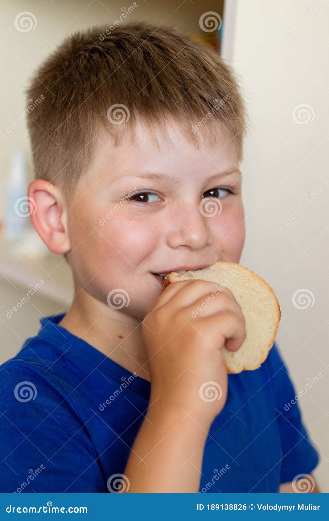 The Boy is Happy To Eat Bread, a Hungry Boy Stock Photo - Image of ...