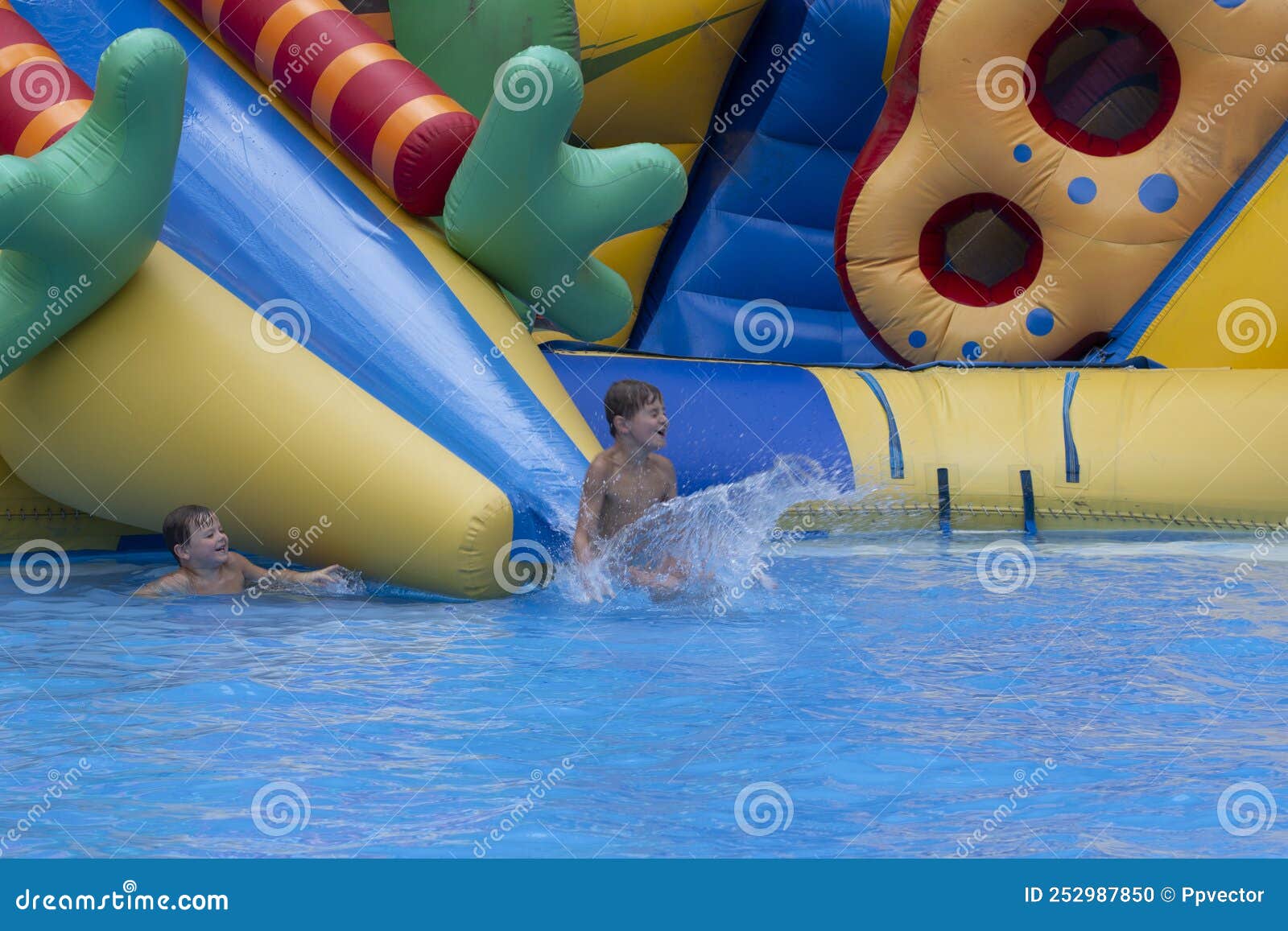 Boy Has into Pool after Going Down Water Slide during Summer. Little ...