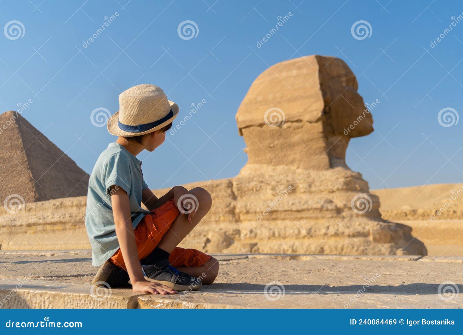 The Boy in Hat Sits in Front of the Sphinx and Looks at it Stock Image ...