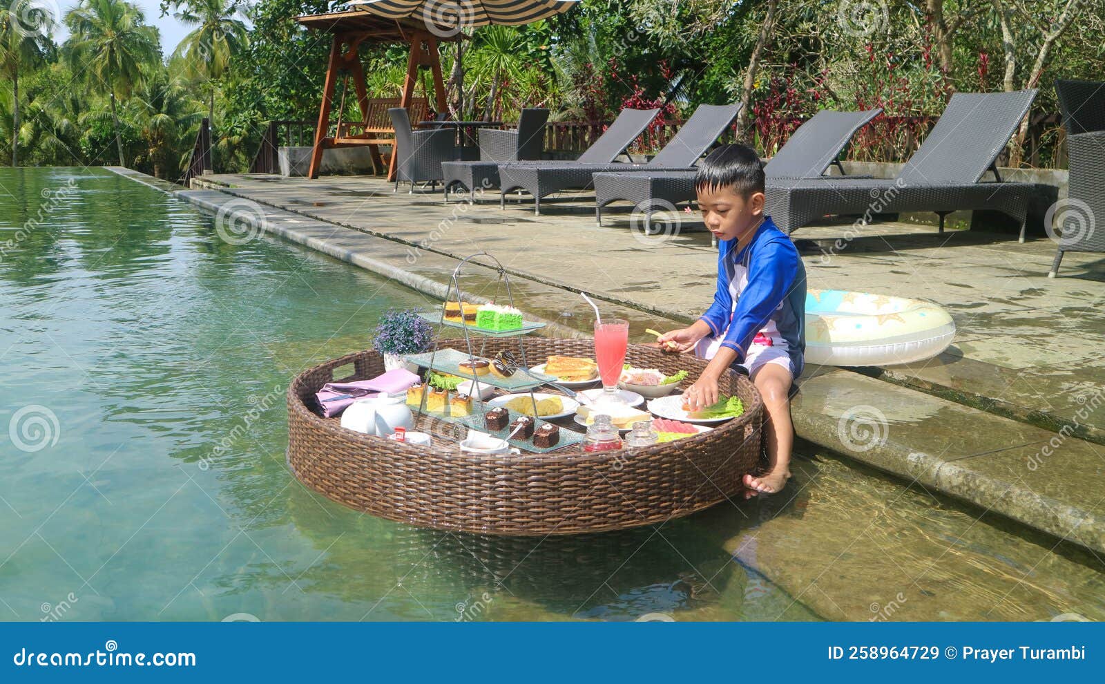 A Boy Having Breakfast Floating in the Pool Stock Image - Image of food ...