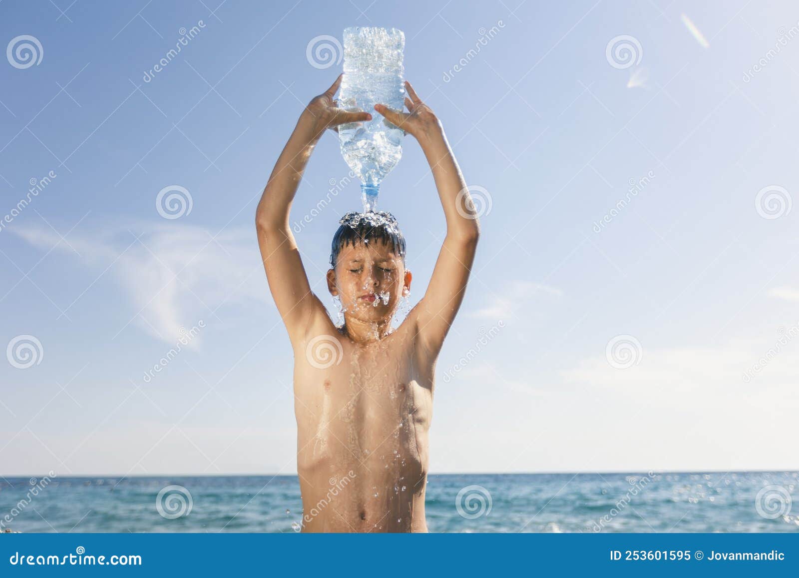 Boy is Having Fun on the Beach, Getting Splashed with Water Stock Image ...
