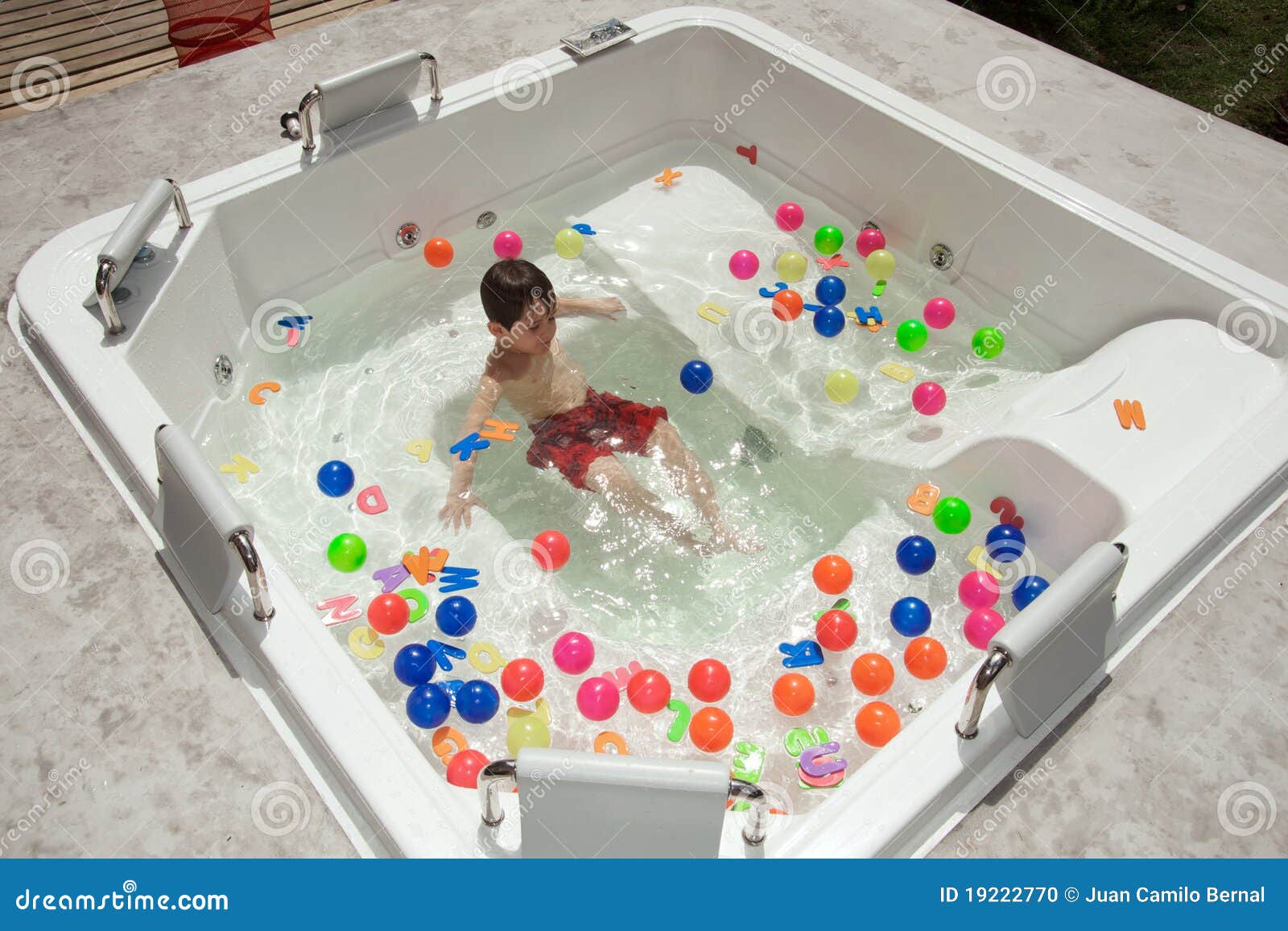 Boy having fun in jacuzzi stock photo. Image of playing - 19222770