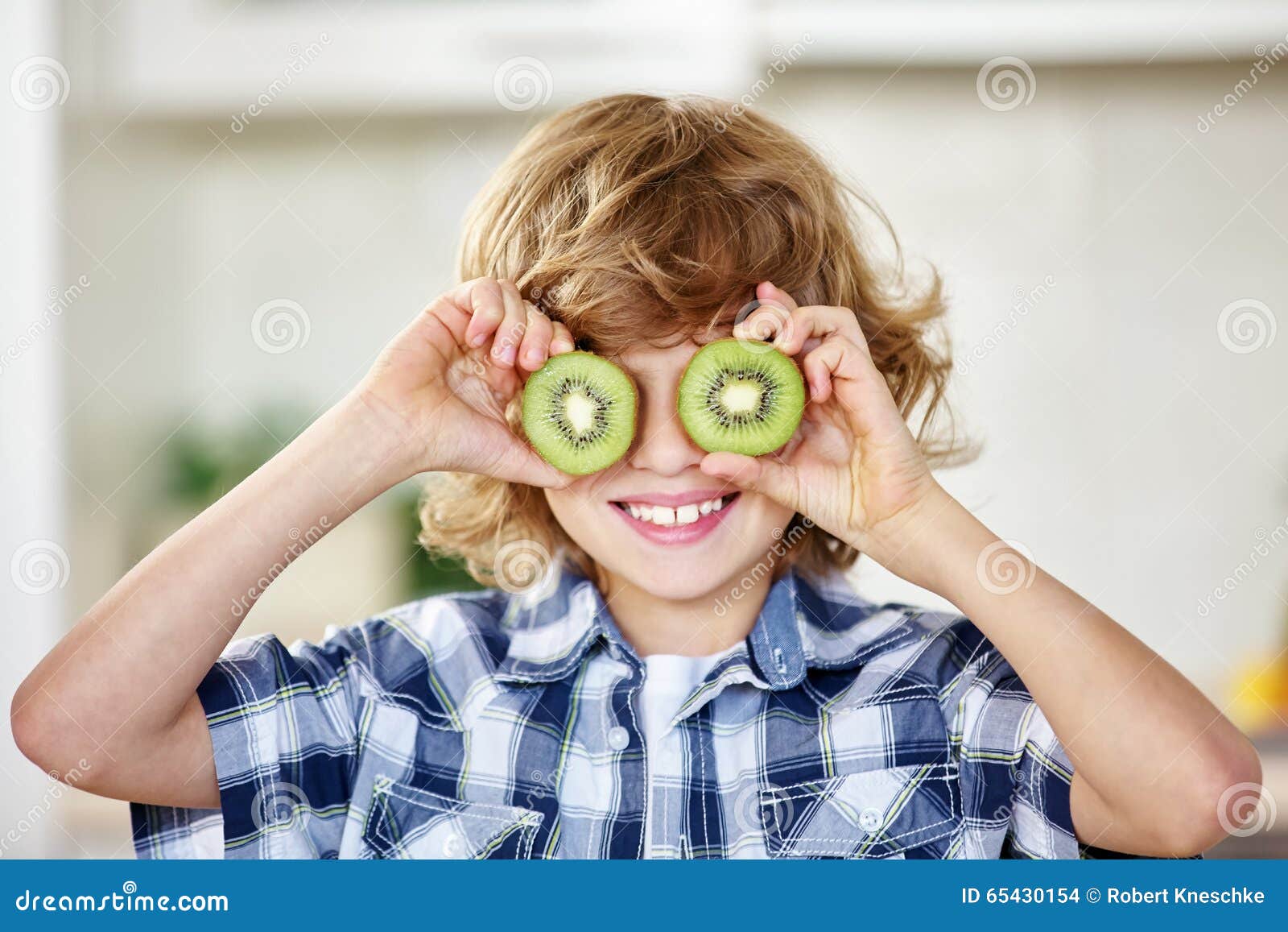 Boy having fun with kiwi stock photo. Image of eyes, life - 65430154