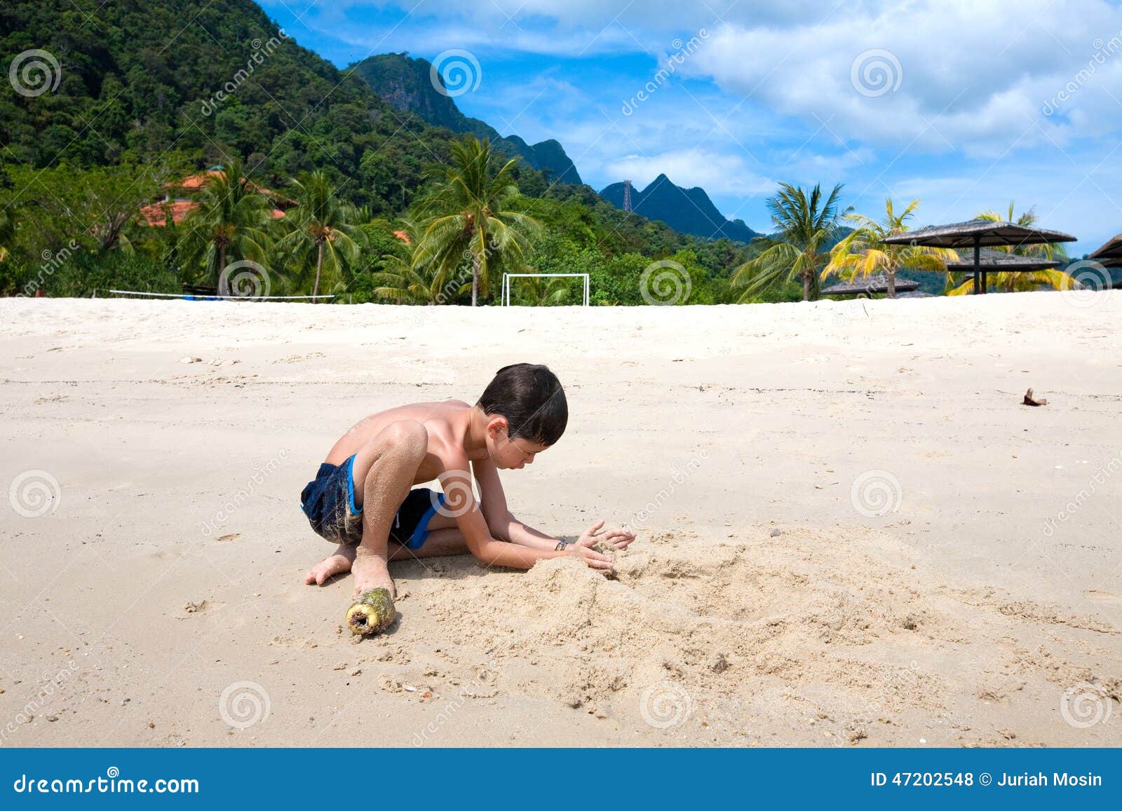 Boy Having Fun Outdoors Playing in the Sand by the Beach in Tropical ...