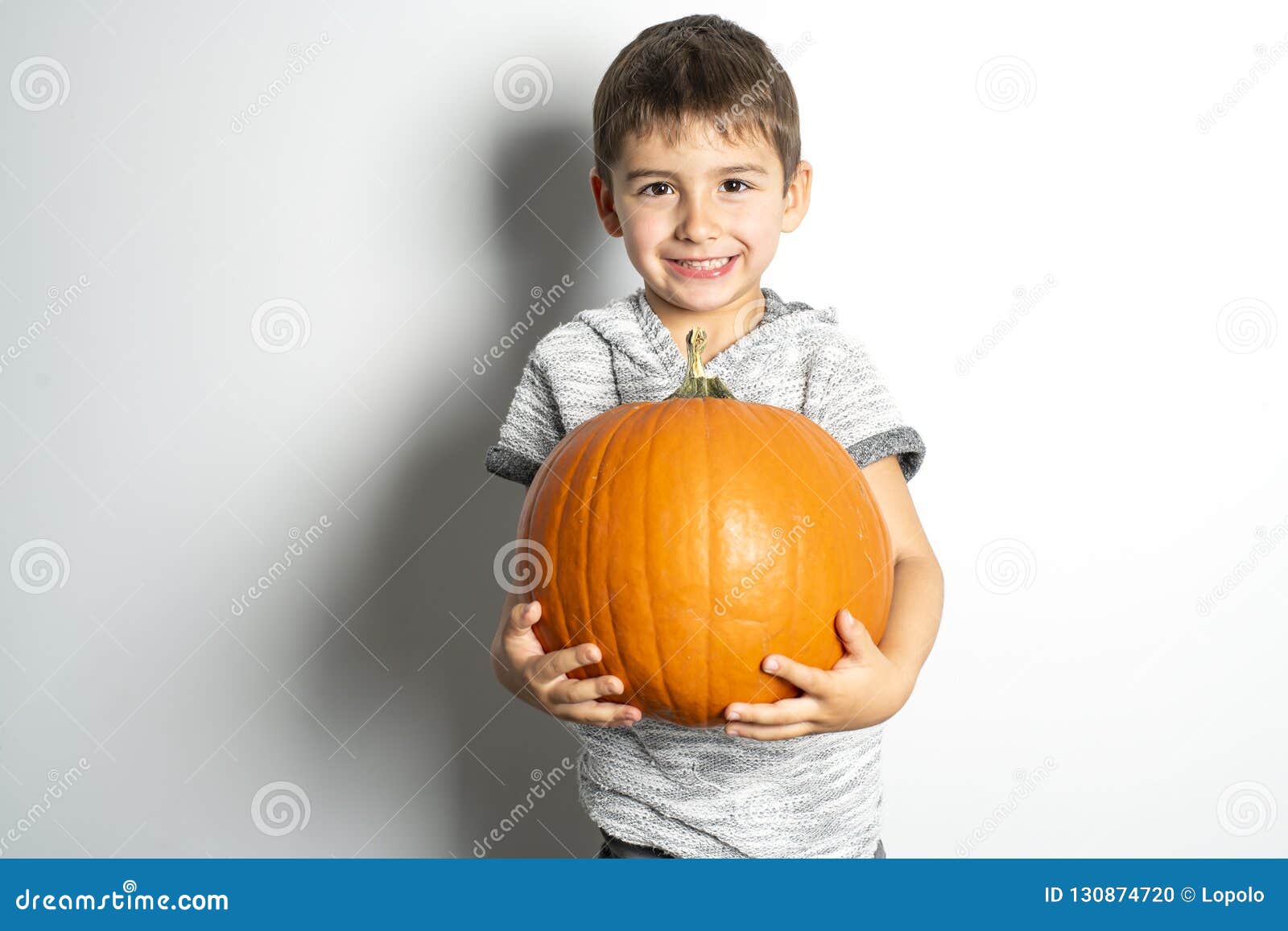 Boy Having Fun on Studio White Background with Pumpkin Stock Photo ...