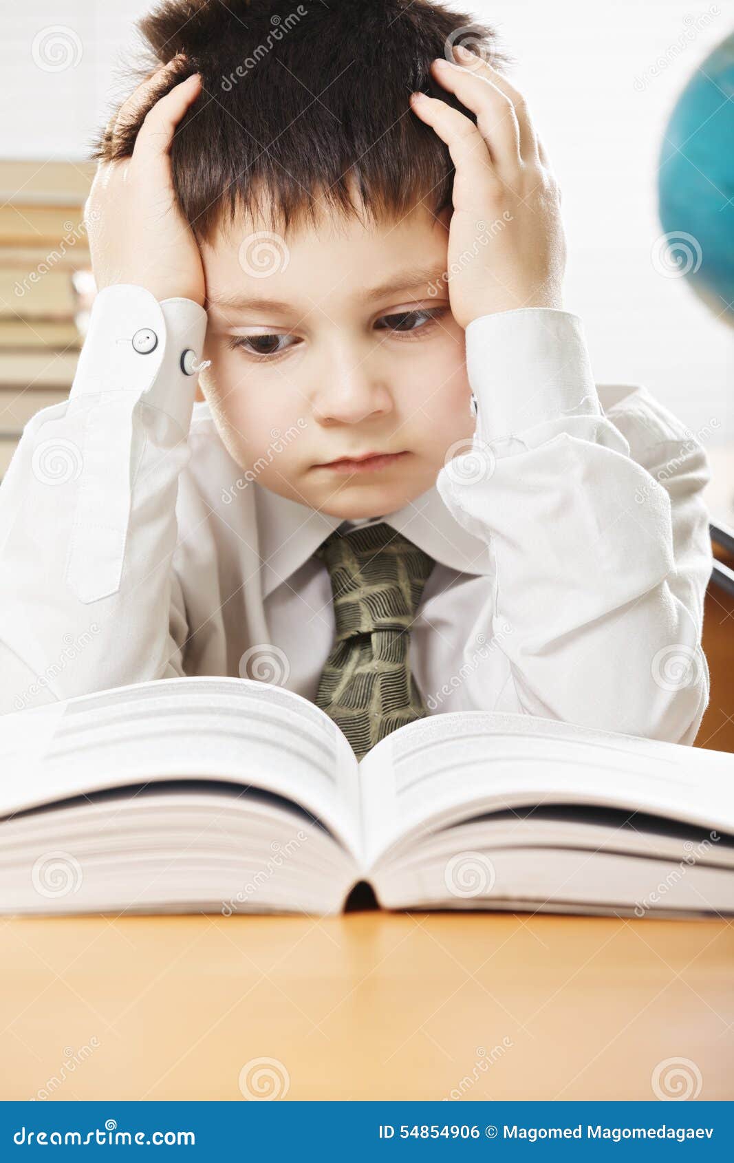 Boy having hard reading stock photo. Image of book, wear - 54854906