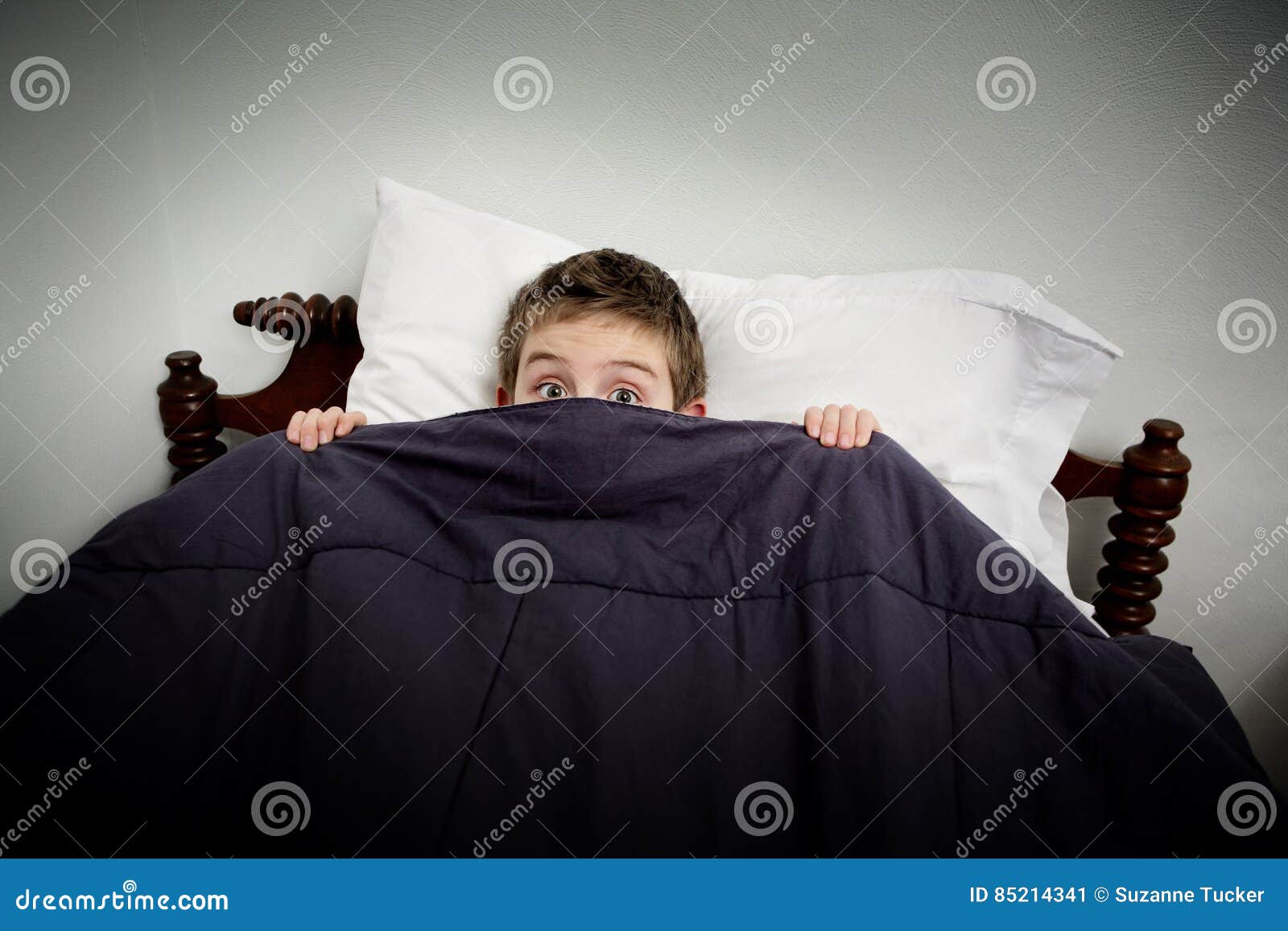 Boy hiding in bed stock image. Image of night, expression - 85214341