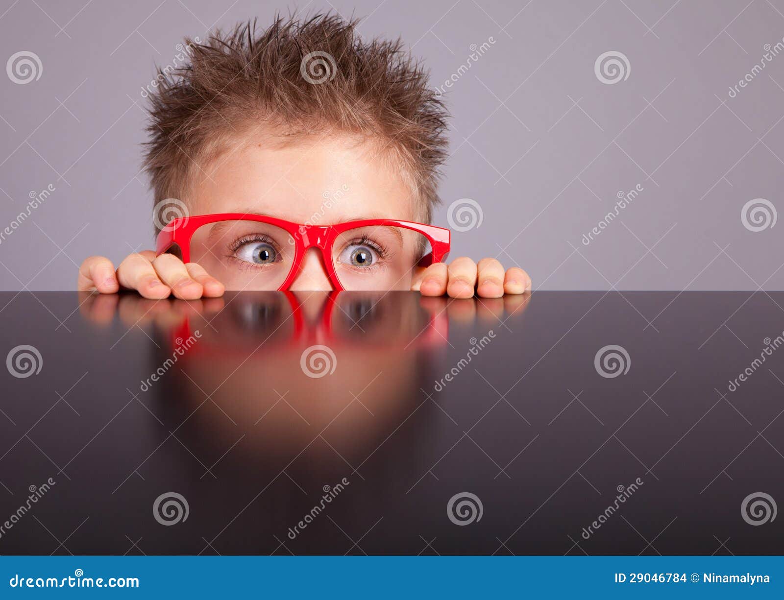 Boy hiding behind a table stock photo. Image of frightened - 29046784