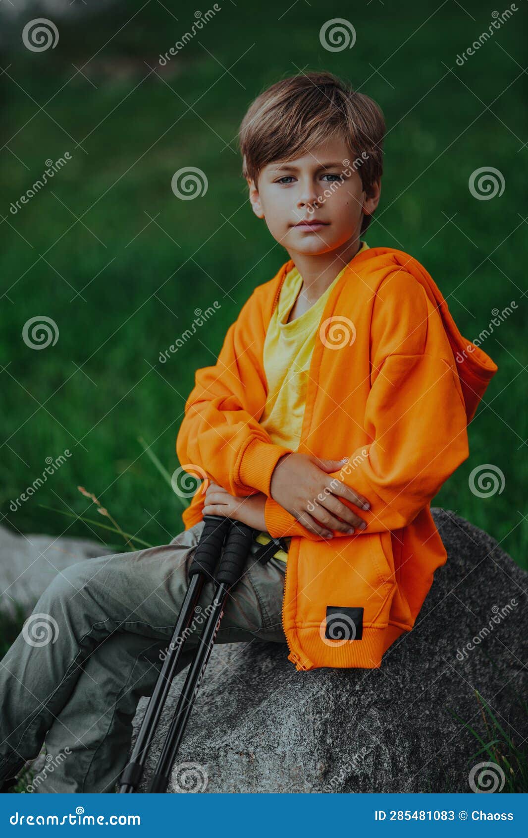 Boy Hiker with Trekking Poles Sitting on Boulder Stock Image - Image of ...