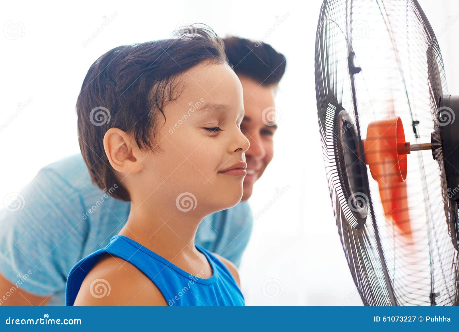 Boy with His Dad Cooling in Front of Fan. Stock Image - Image of ...