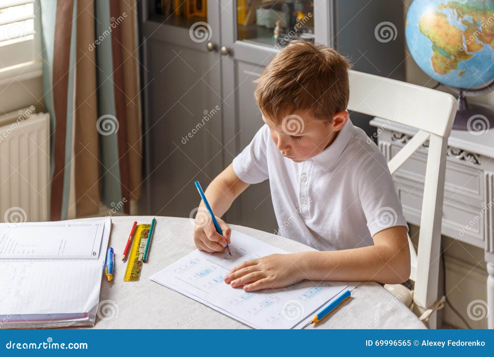 Boy at his homework stock image. Image of full, light - 69996565