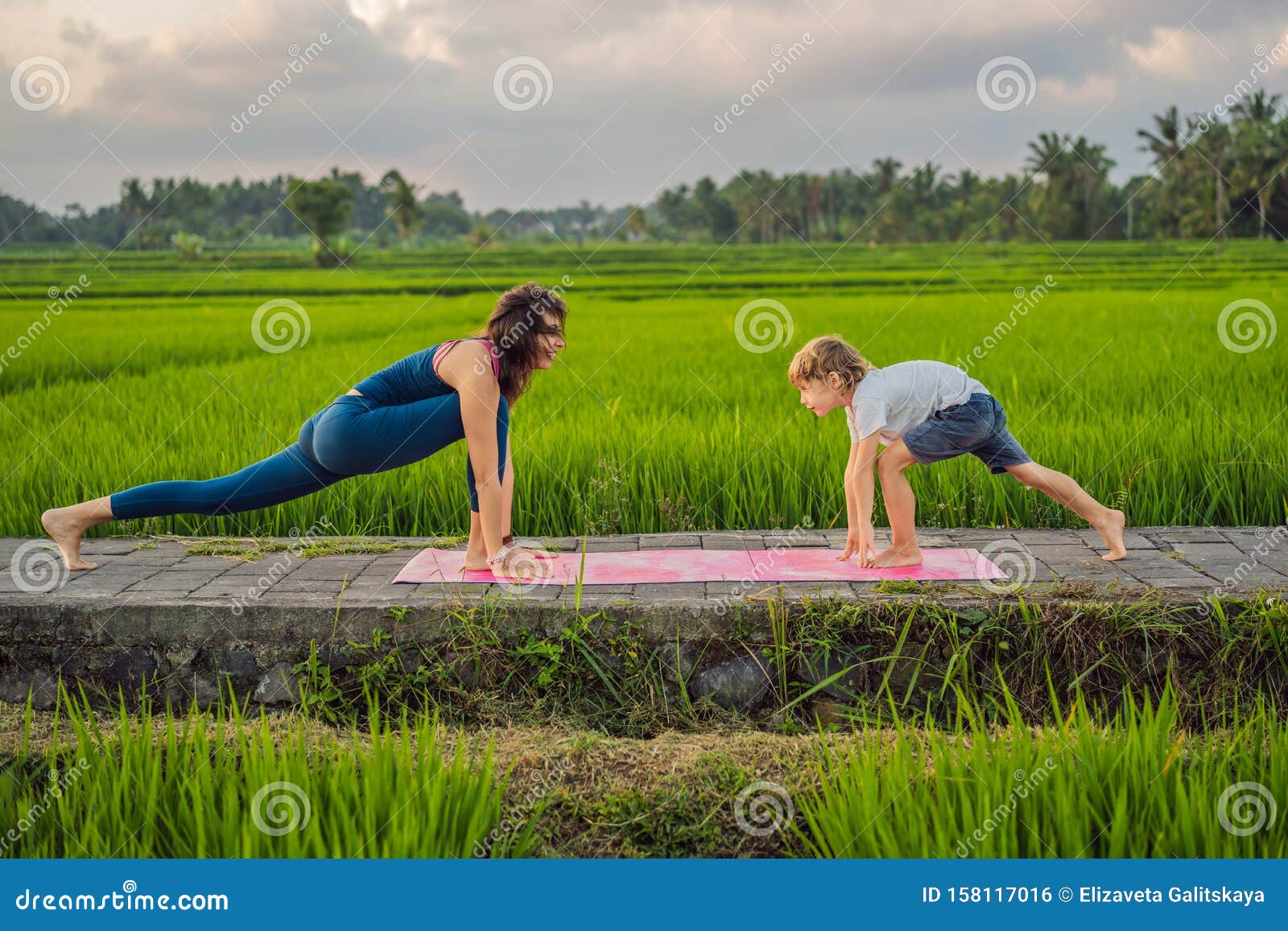 Boy and His Yoga Teacher Doing Yoga in a Rice Field Stock Photo - Image ...