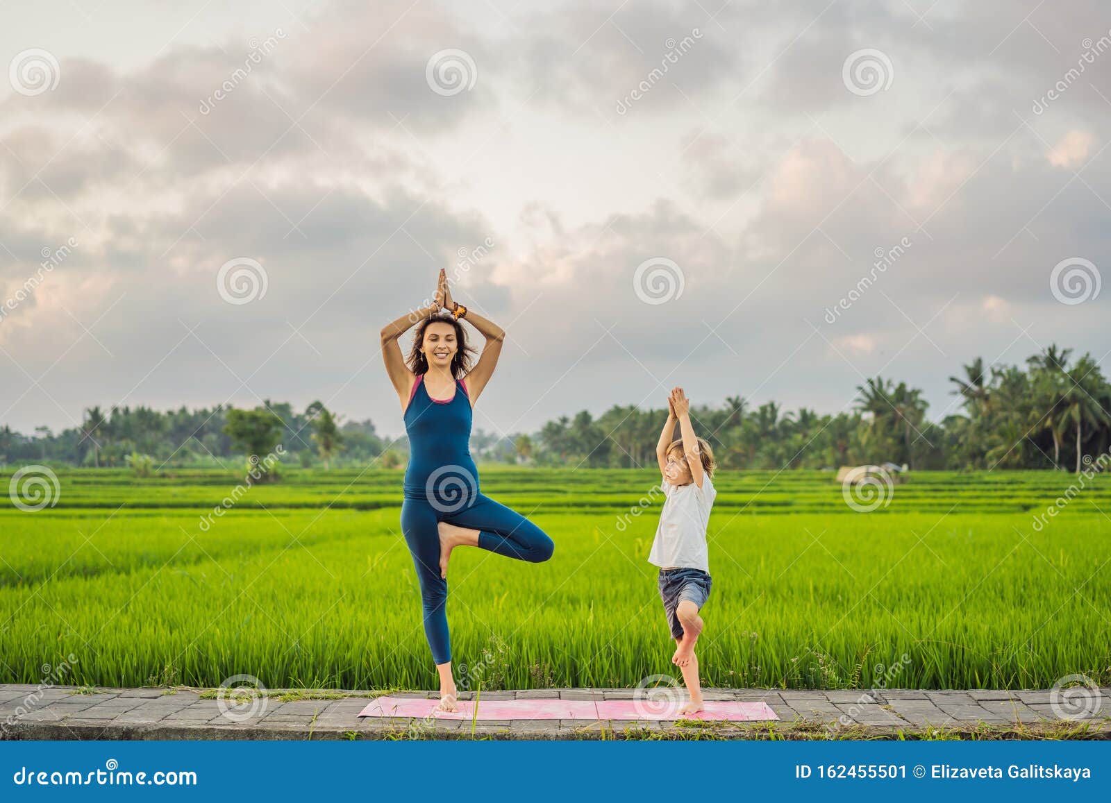 Boy and His Yoga Teacher Doing Yoga in a Rice Field Stock Image - Image ...