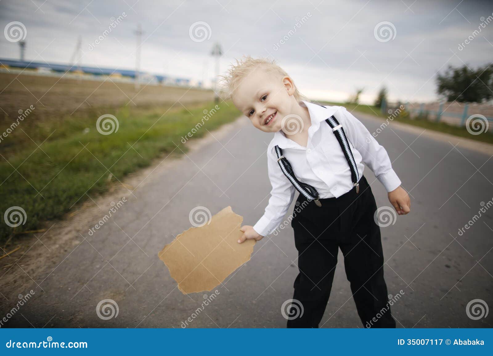 Boy hitch hiking at road stock image. Image of holding - 35007117