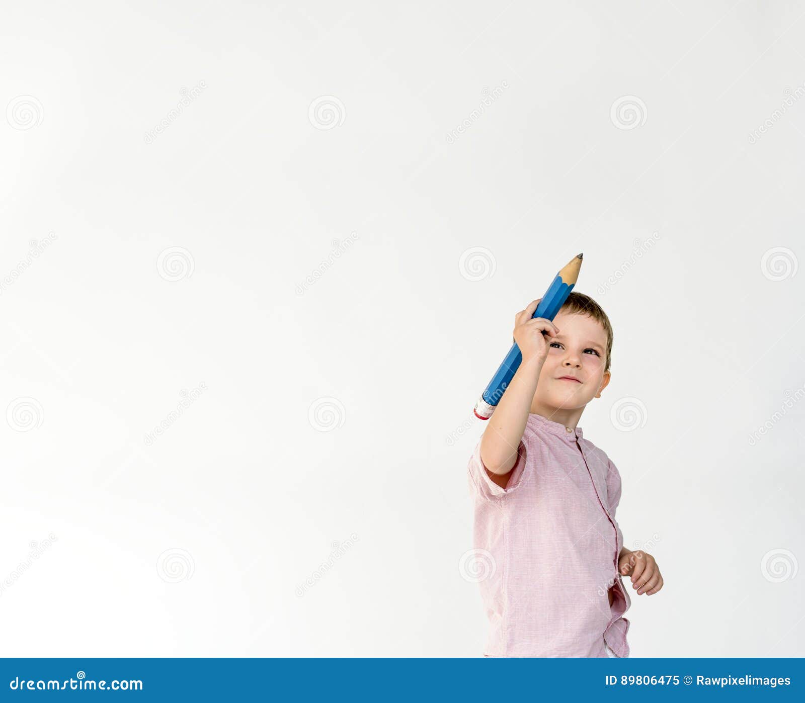 A Boy Hold Pencil Writing in a Shoot Stock Image - Image of studio ...
