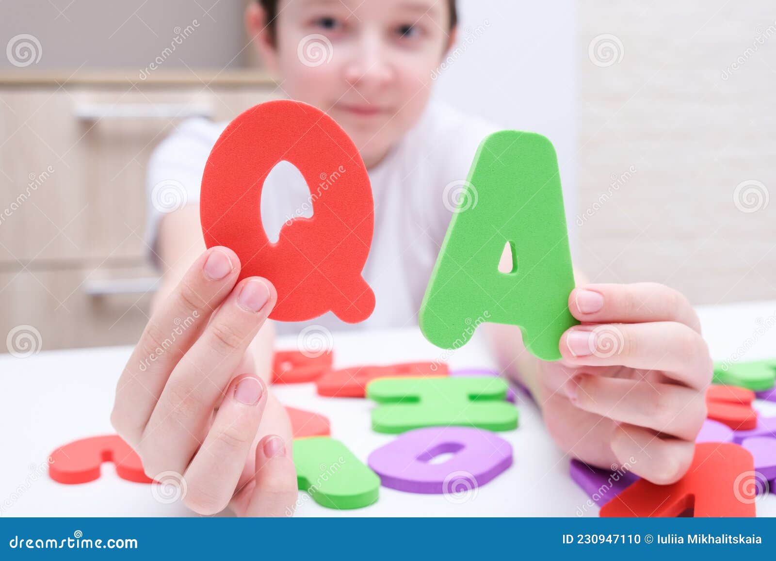 A Boy Holding Colorful Letters Q and a, Questions and Answers Concept ... A Boy Holding Colorful Letters Q and a, Questions and Answers Concept ...